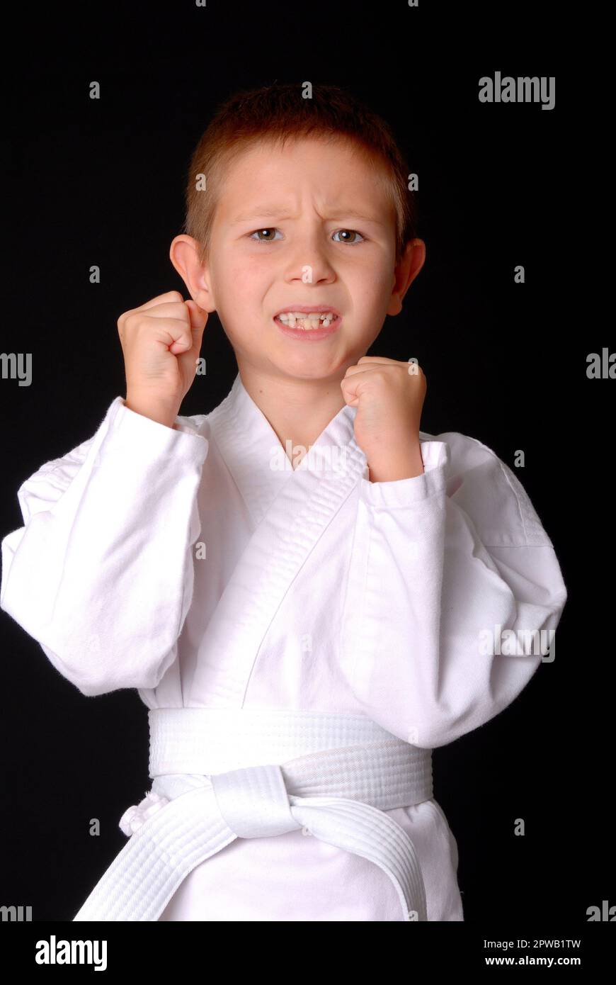 Young boy in karate outfit making fighting movement Stock Photo - Alamy
