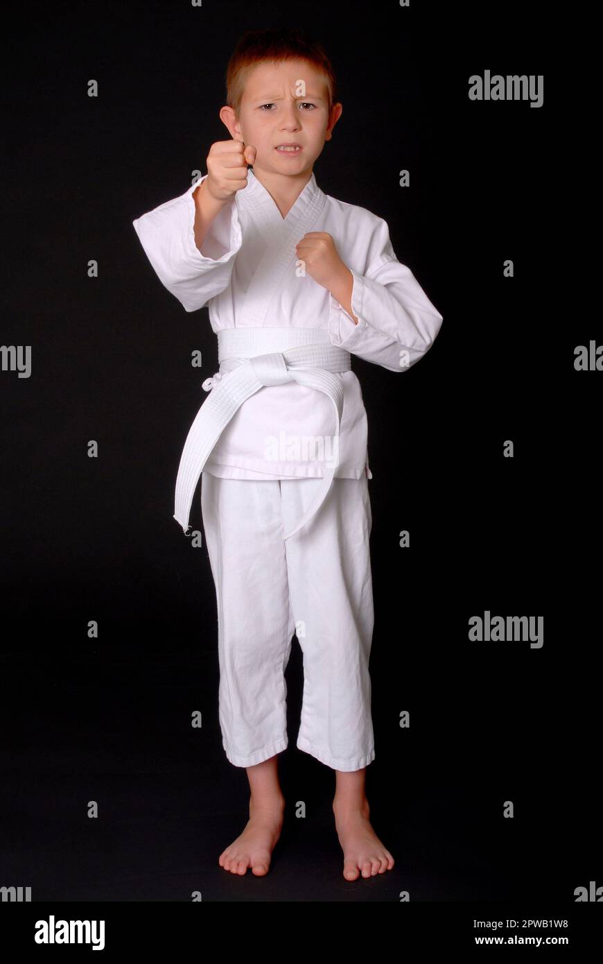 Young boy in karate outfit making fighting movement Stock Photo - Alamy