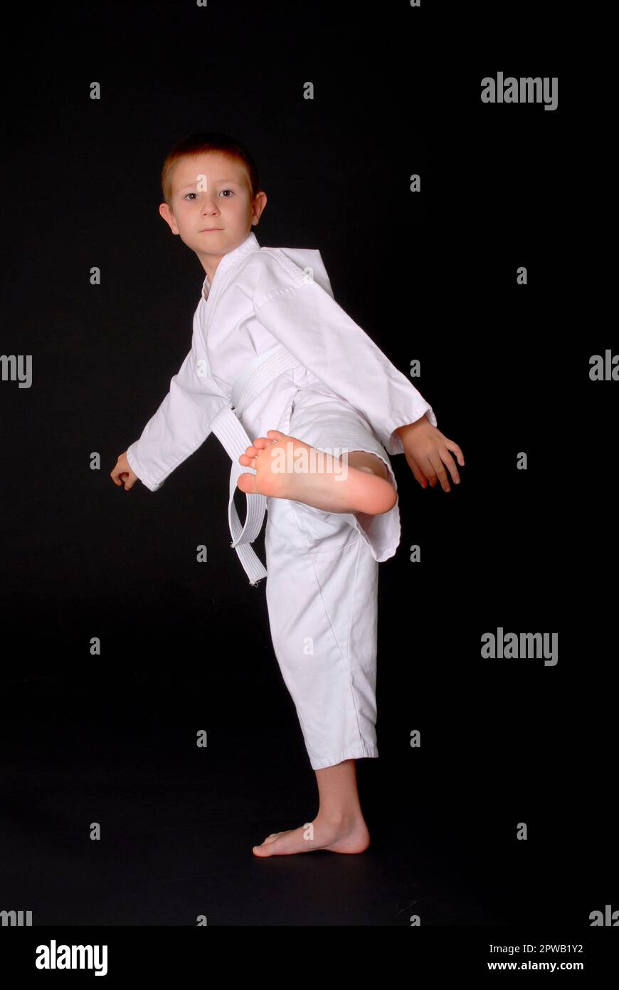 Young boy in karate outfit making fighting movement Stock Photo - Alamy