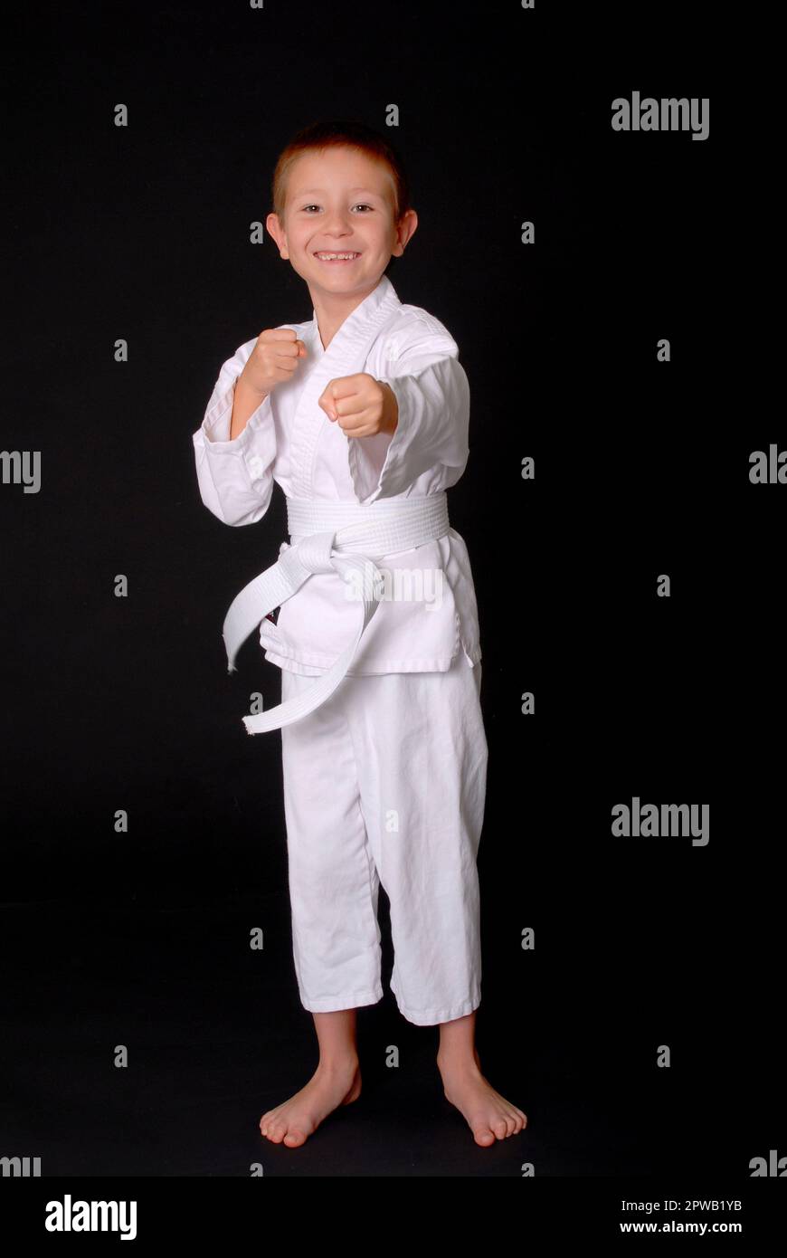 Young boy in karate outfit making fighting movement Stock Photo - Alamy