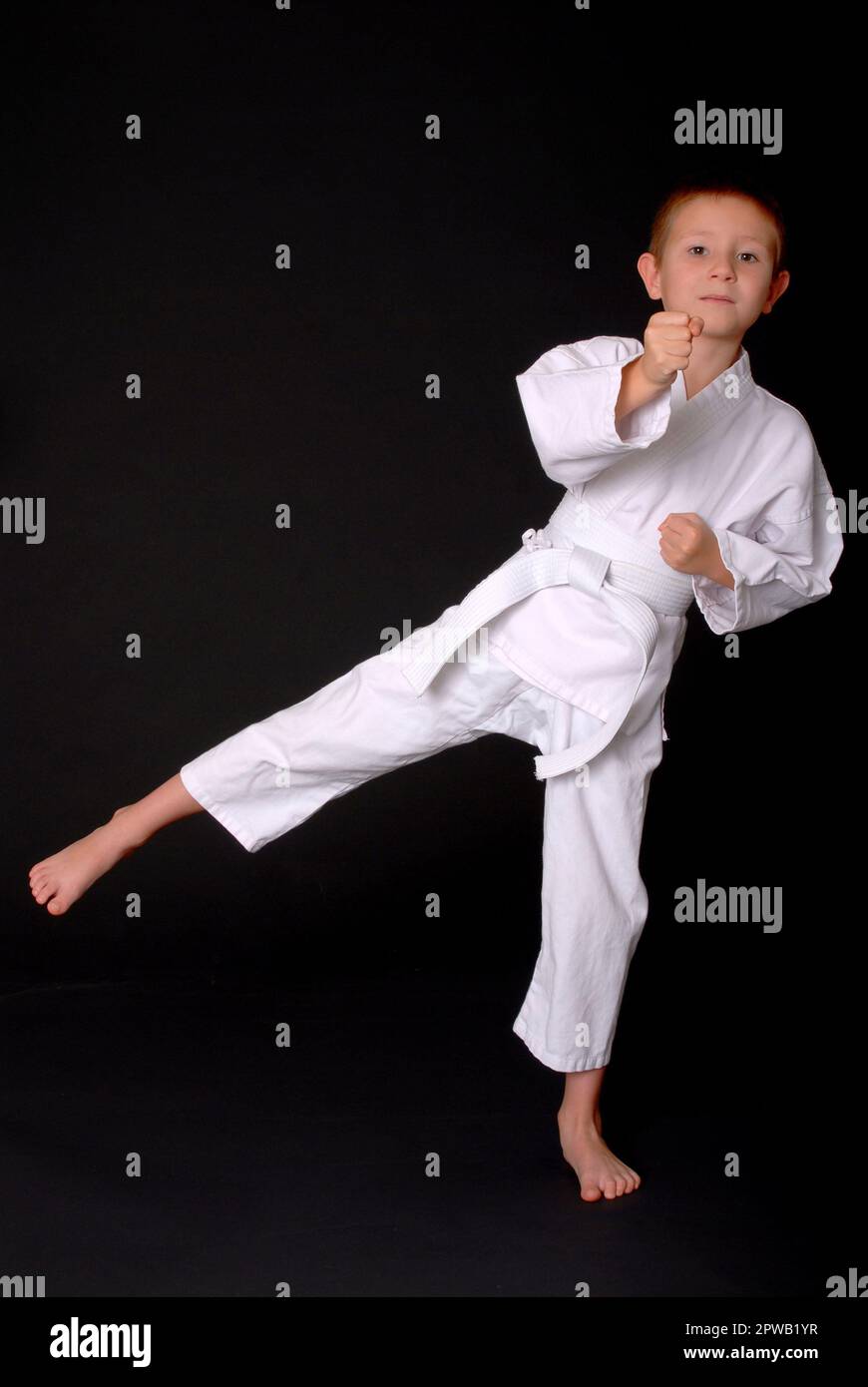 Young boy in karate outfit making fighting movement Stock Photo - Alamy