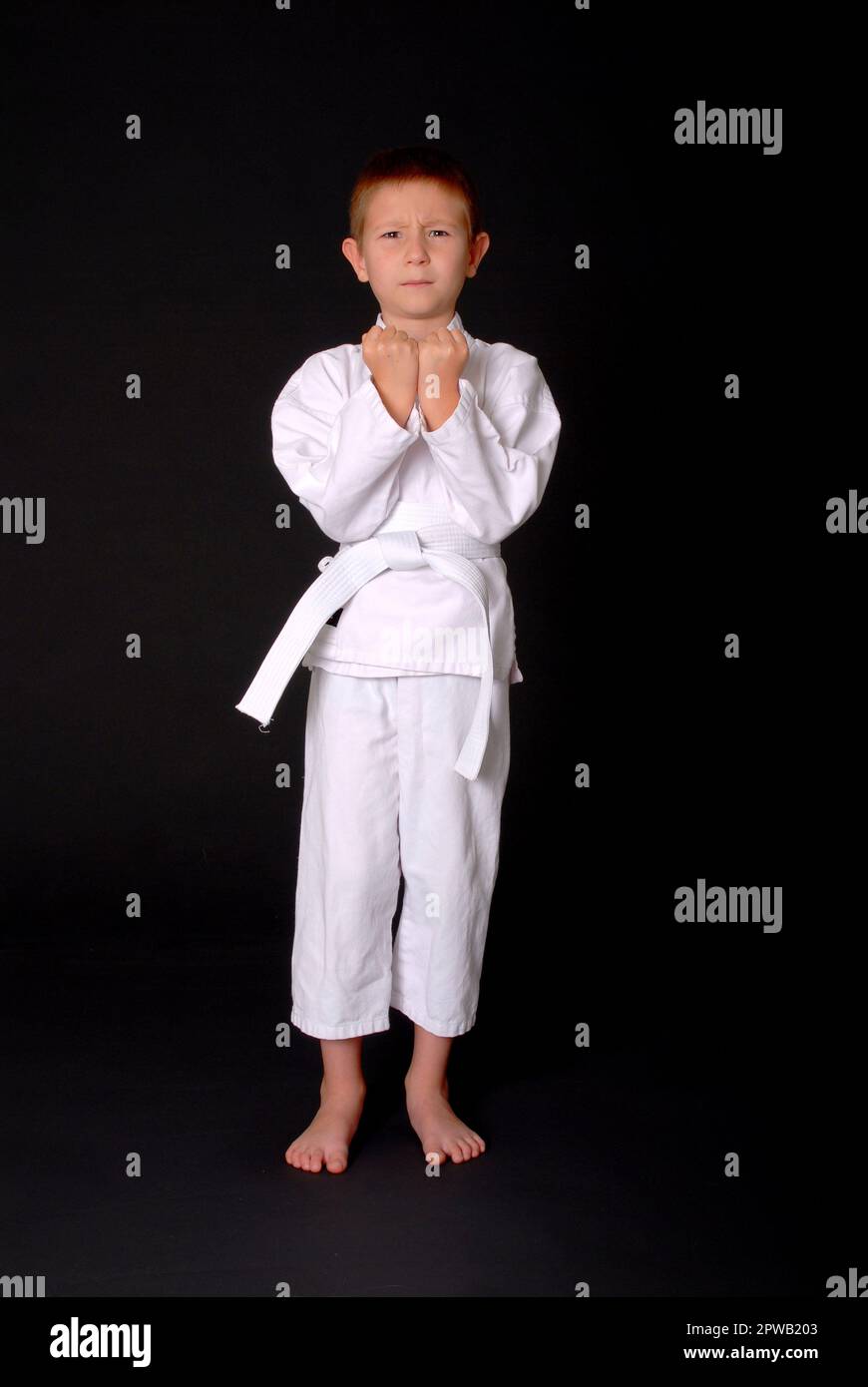 Young boy in karate outfit making fighting movement Stock Photo - Alamy