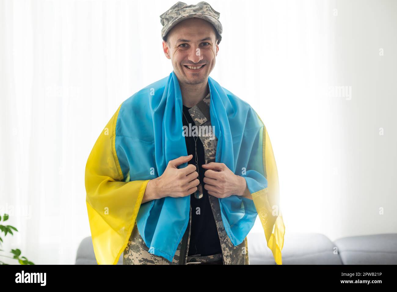 Ukrainian man warrior dressed in a military pixel uniform holds the ...