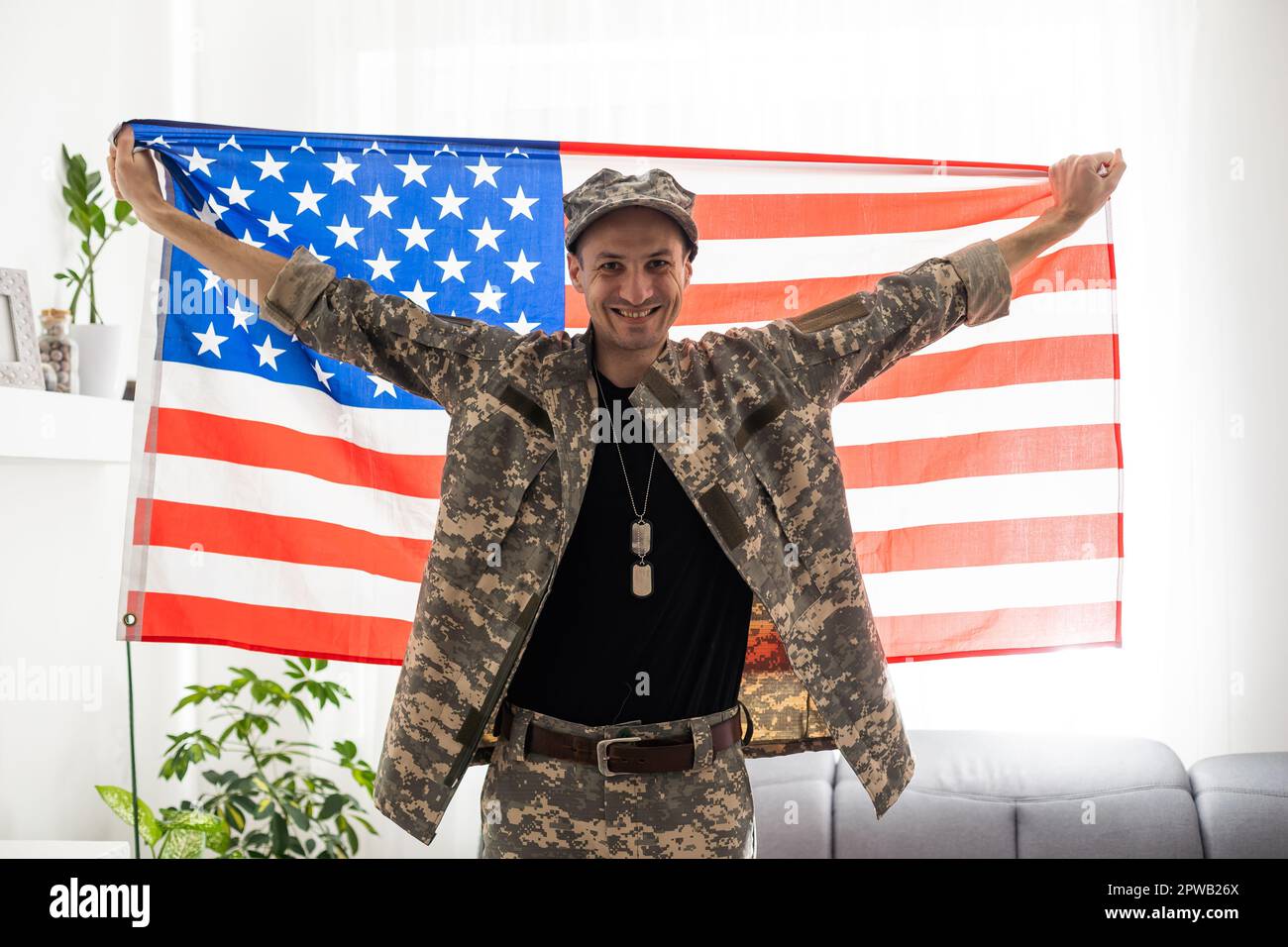 upset American soldier holding flag of United States while crying ...