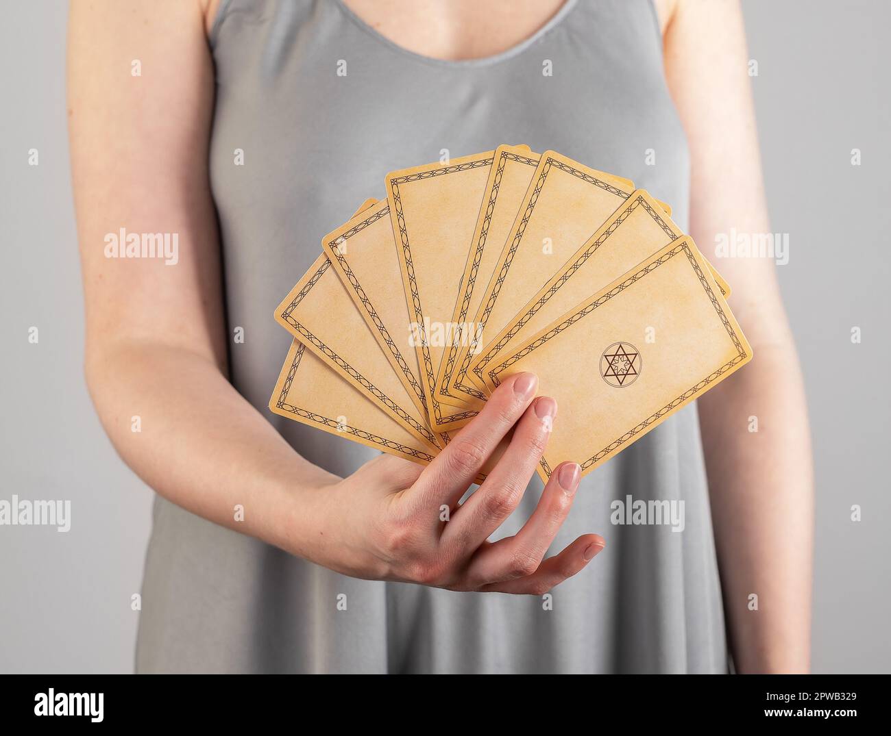 Lodz, Poland April 07 2023 Hand showing tarot cards backside, back ...