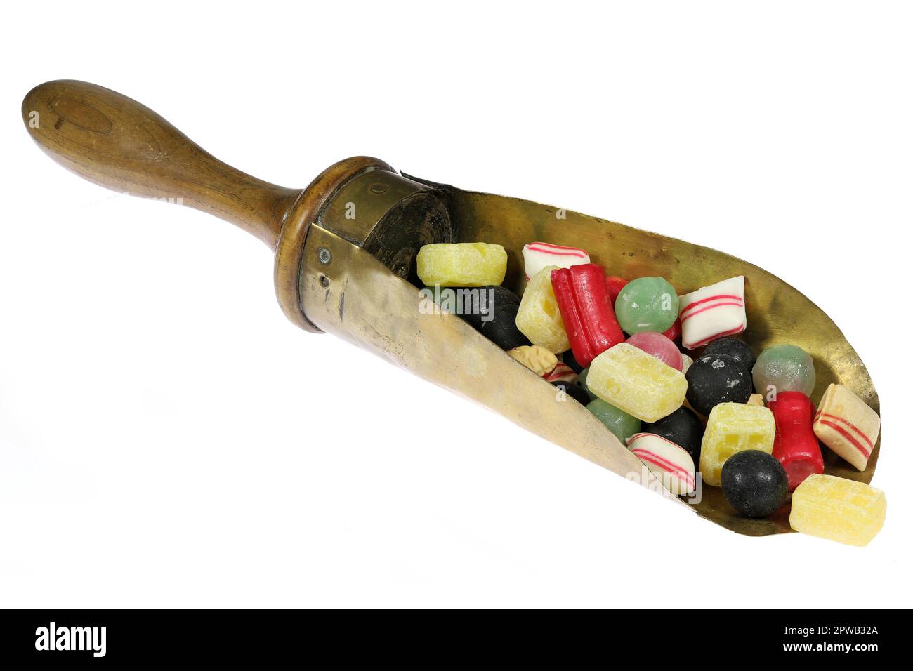 classic Dutch candies in a vintage brass weighing scoop isolated on ...
