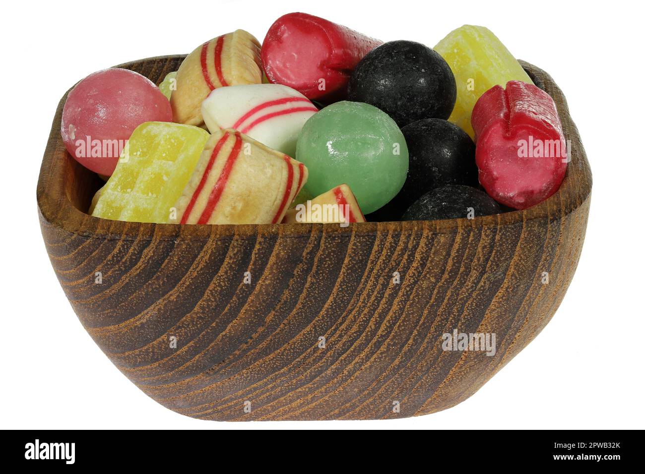 classic Dutch candies in a wooden bowl isolated on white background ...