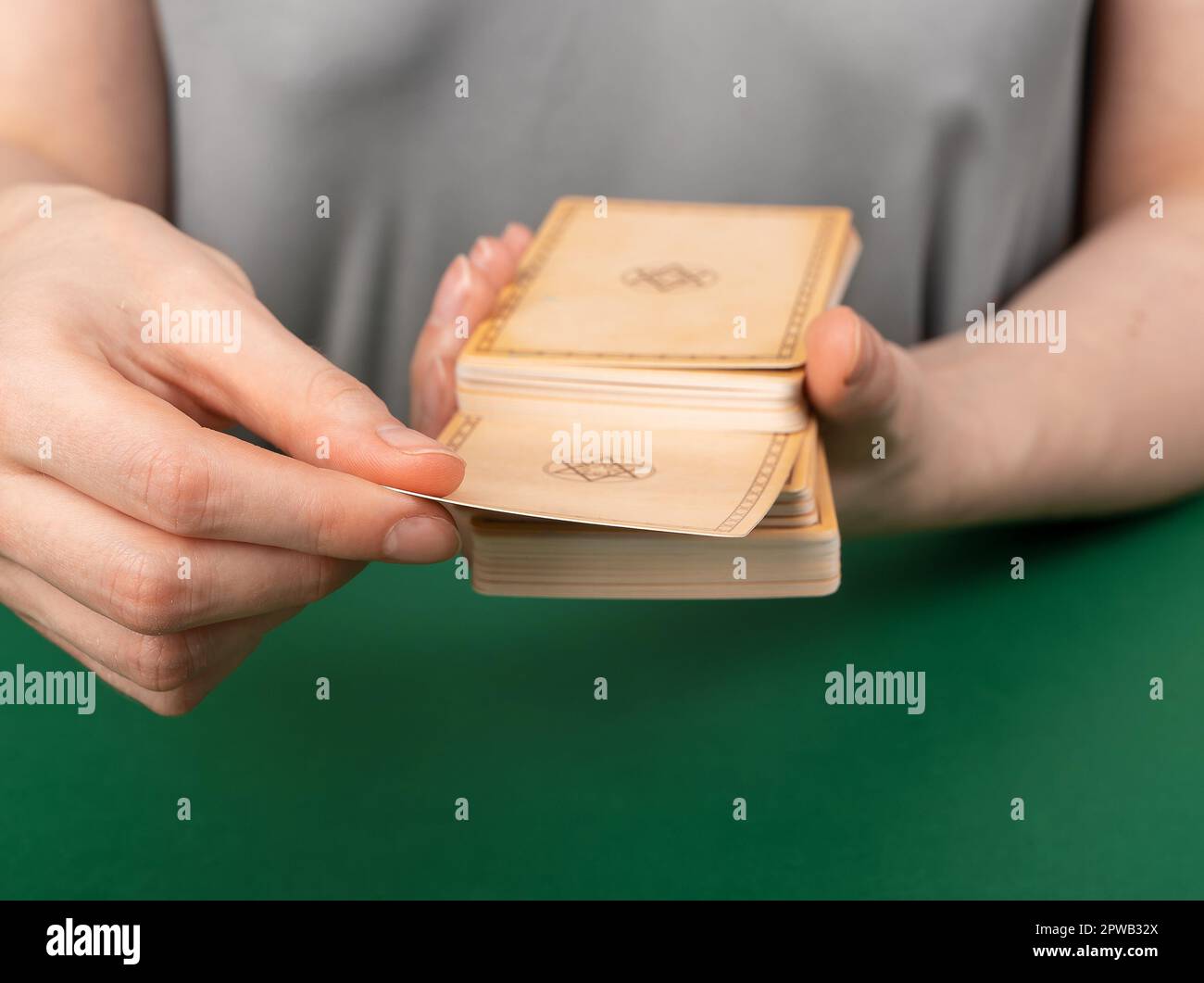 Hands with tarot cards, dividing deck into two parts for divination ...