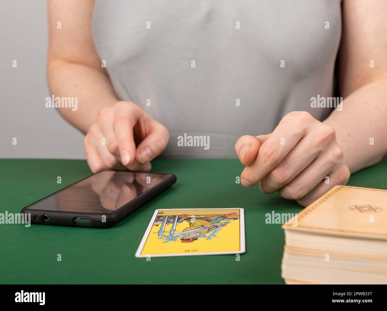 Lodz, Poland March 31 2023 Tarot card reader with mobile phone ...