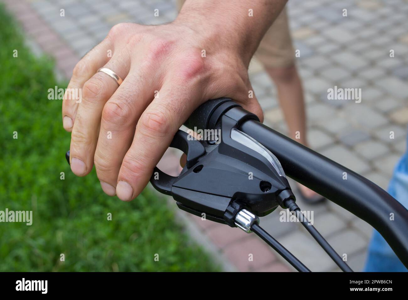 The man brakes on the bike by pressing the brake lever Stock Photo - Alamy
