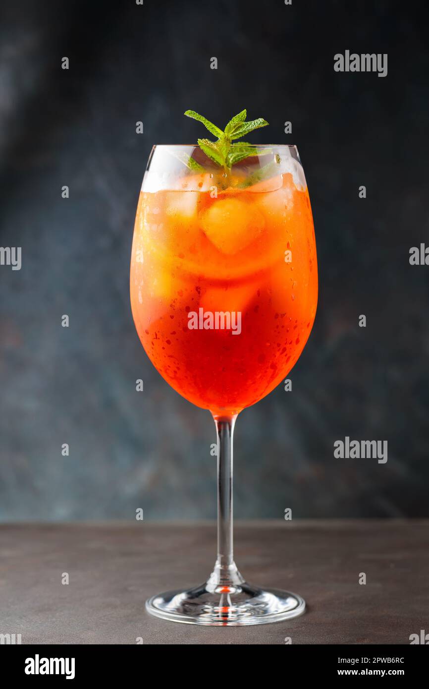 Aperol Spritz cocktail in glass with orange and fresh mint on dark ...