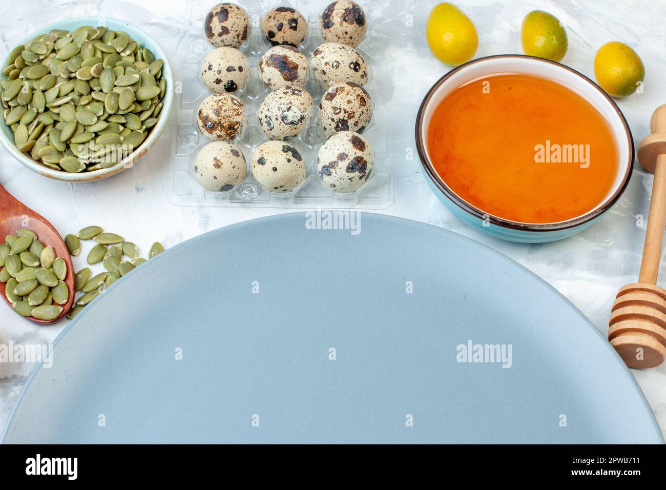 front view round blue plate with flour jelly eggs and different nuts on ...
