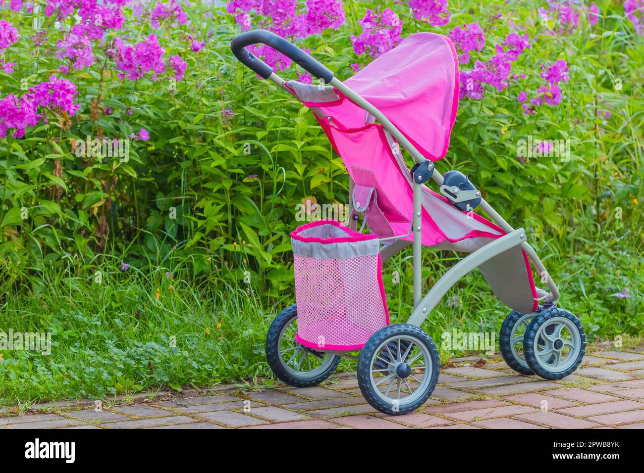 Baby pink stroller forgotten in a city park. The child lost the pram ...