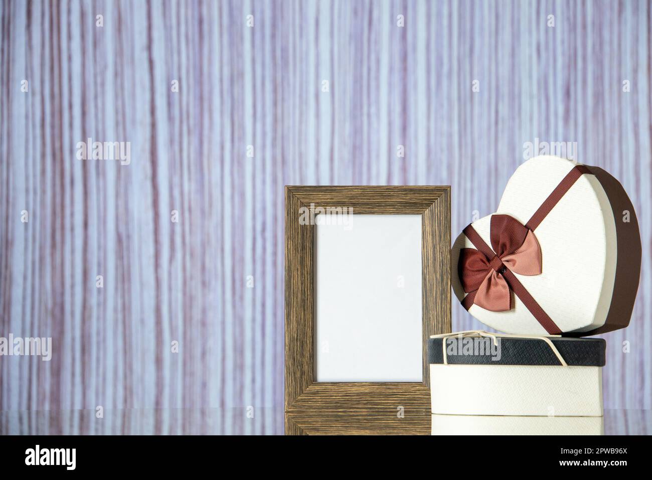 front view valentines day presents with empty picture frame on light ...