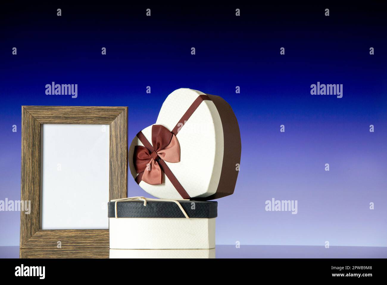 front view valentines day presents with picture frame on blue ...