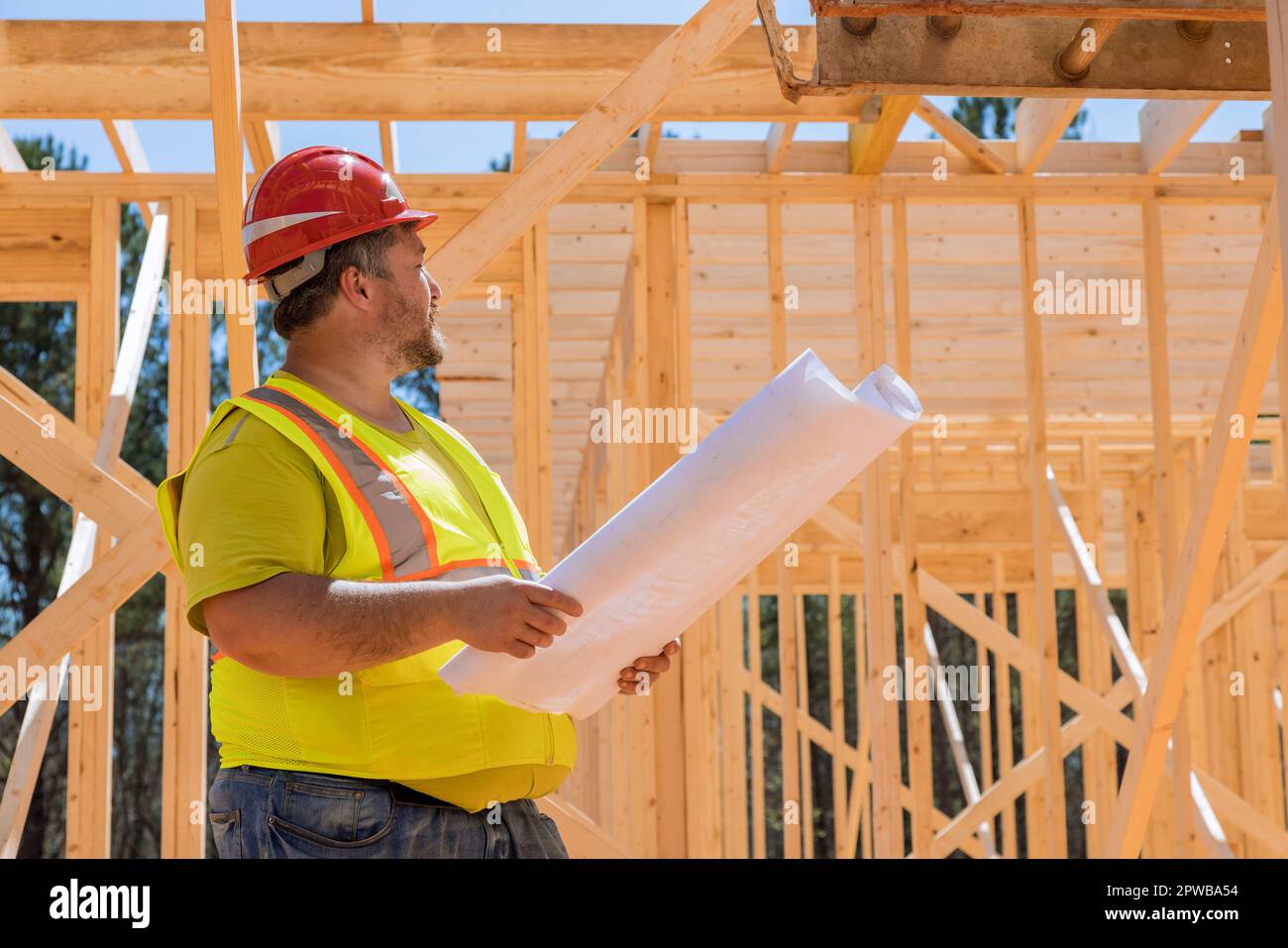 Construction engineer checking quality works of wooden frame using ...