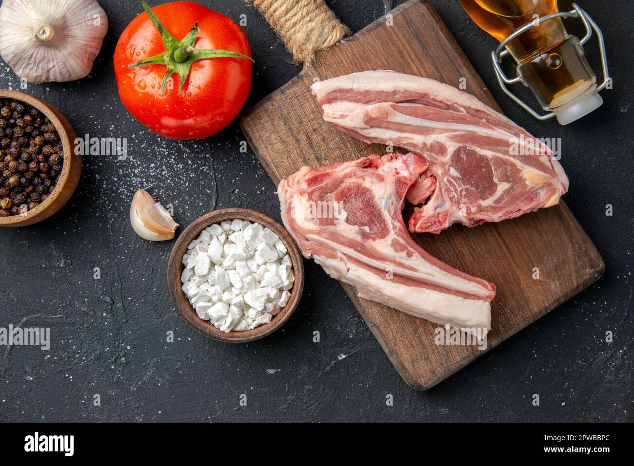 top view fresh meat ribs raw meat with oil and garlic on dark ...