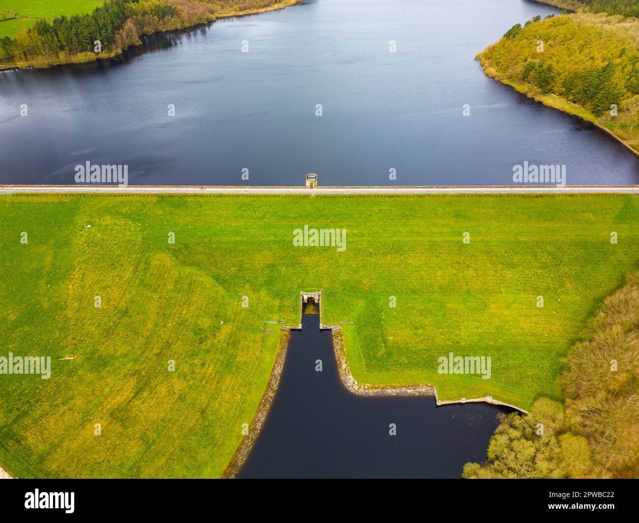 Aerial view of Fewston Reservoir dam feeding into Swinsty Reservoir in ...