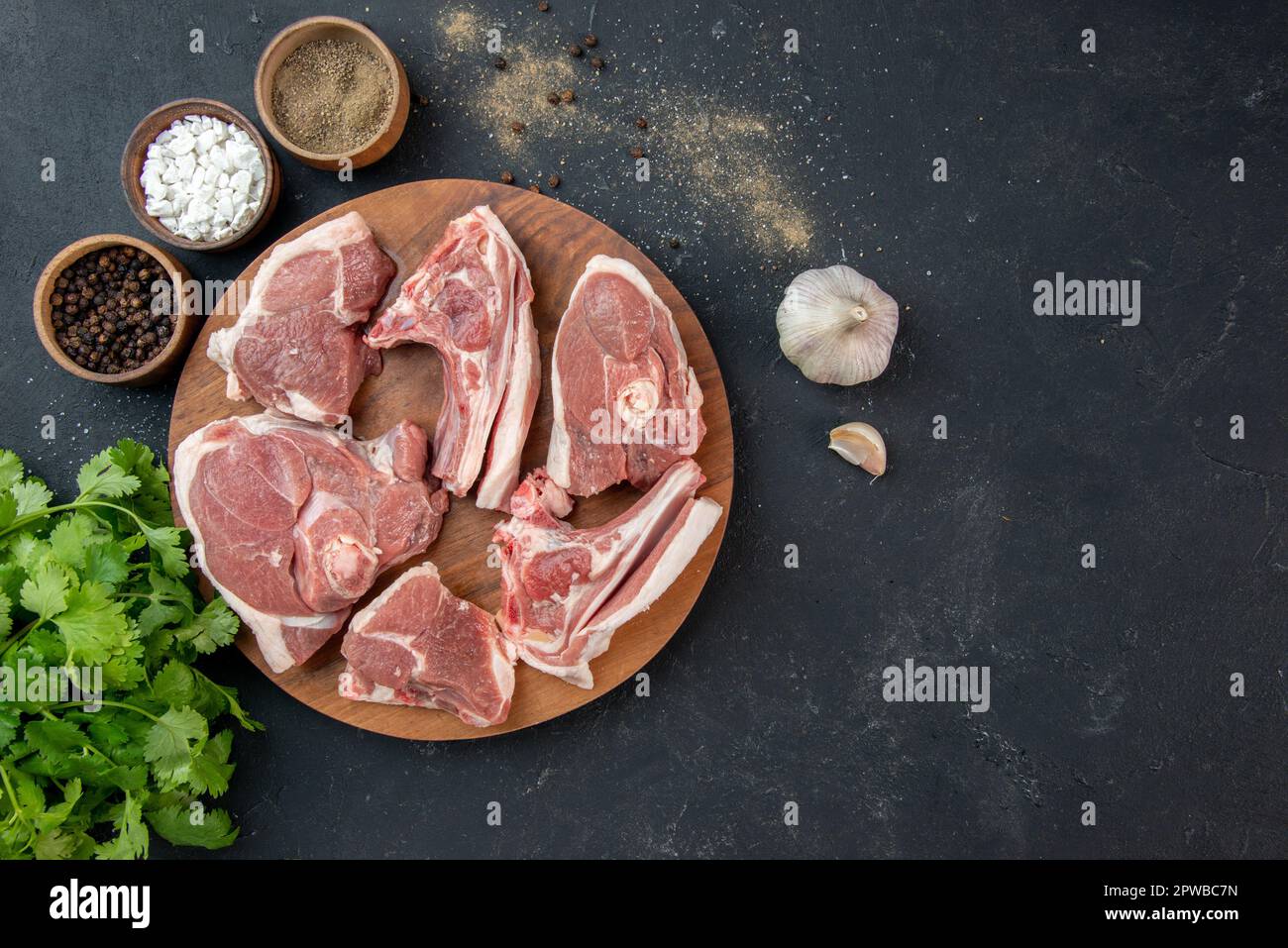 top view fresh meat slices raw meat with seasonings on dark background ...