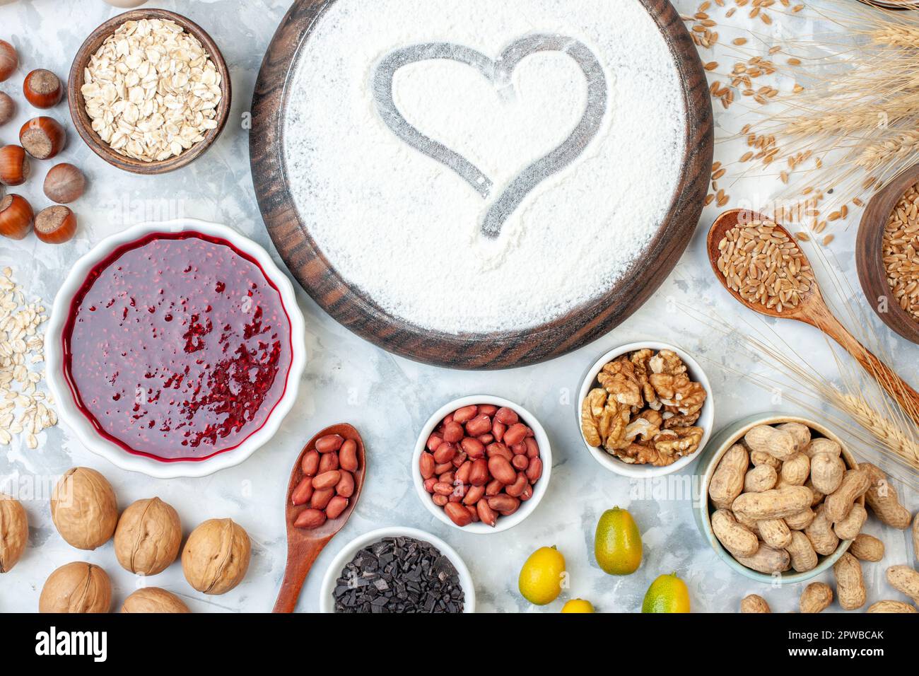 top view heart shaped flour with jelly eggs different nuts and seeds on ...