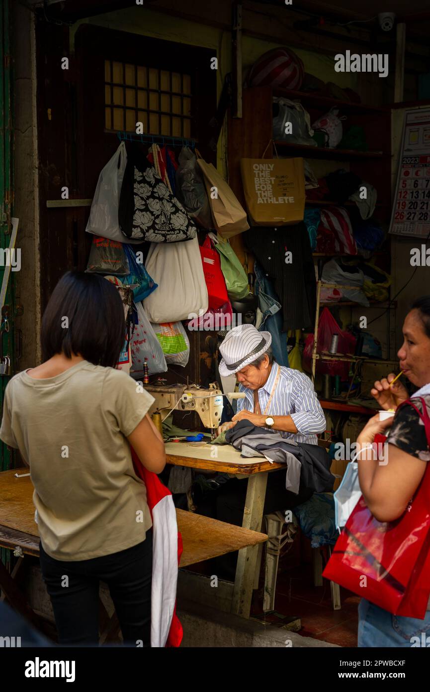Filipino tailors working hard altering clothes, Manila, The Philippines ...