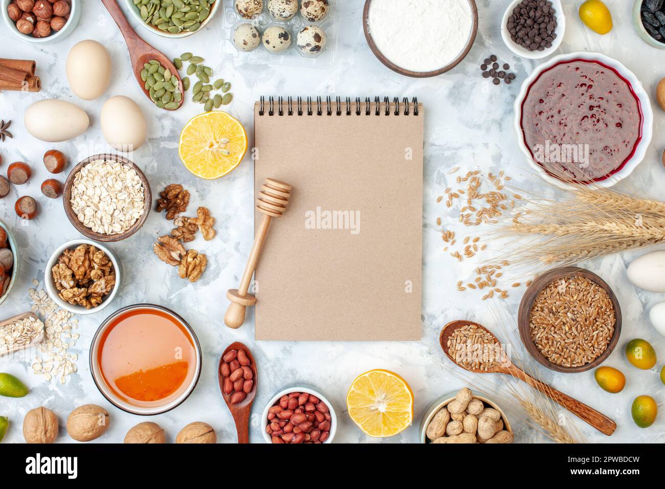 top view simple notepad with eggs flour jelly different nuts and seeds ...