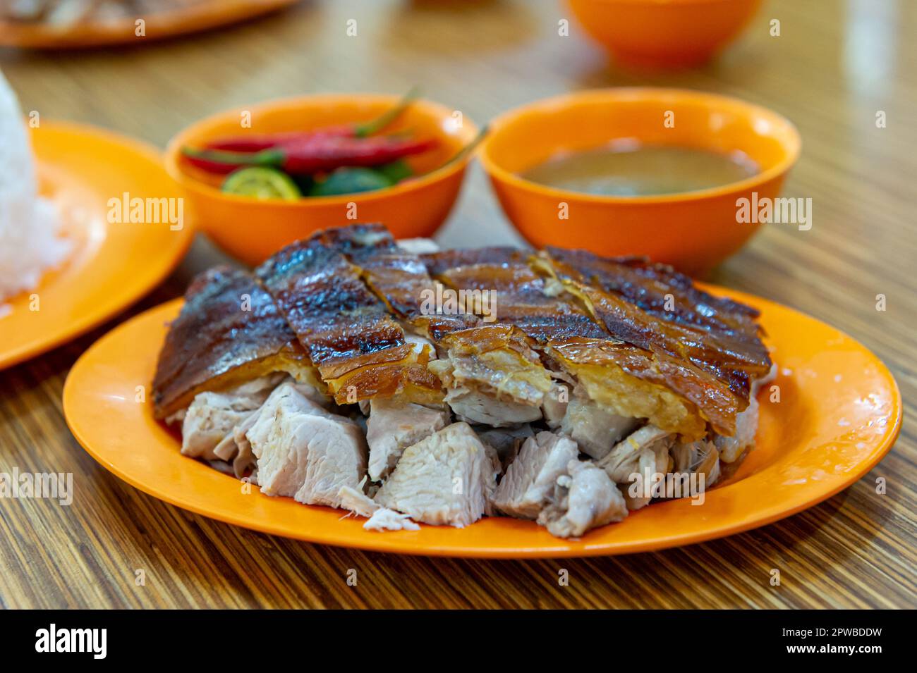 Lechon served with limes and chili, a Filipino delicacy Stock Photo - Alamy