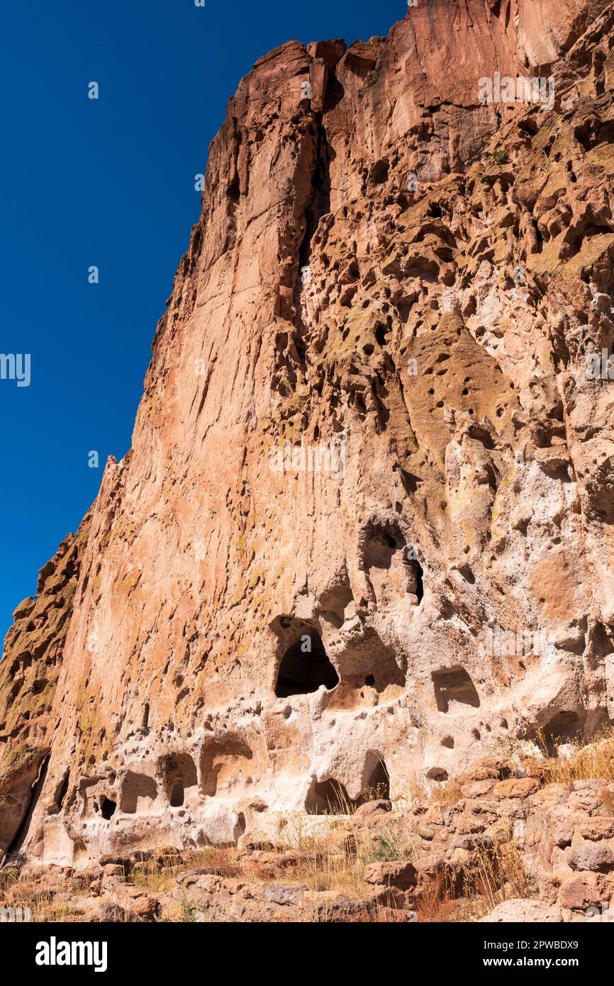 Vertical image of a cliff pock-marked with caves and holes from an ...