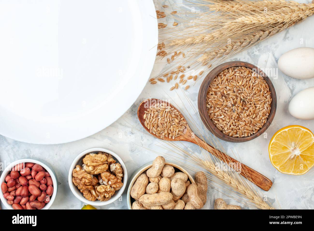 top view white plate with jelly eggs different nuts and seeds on the ...