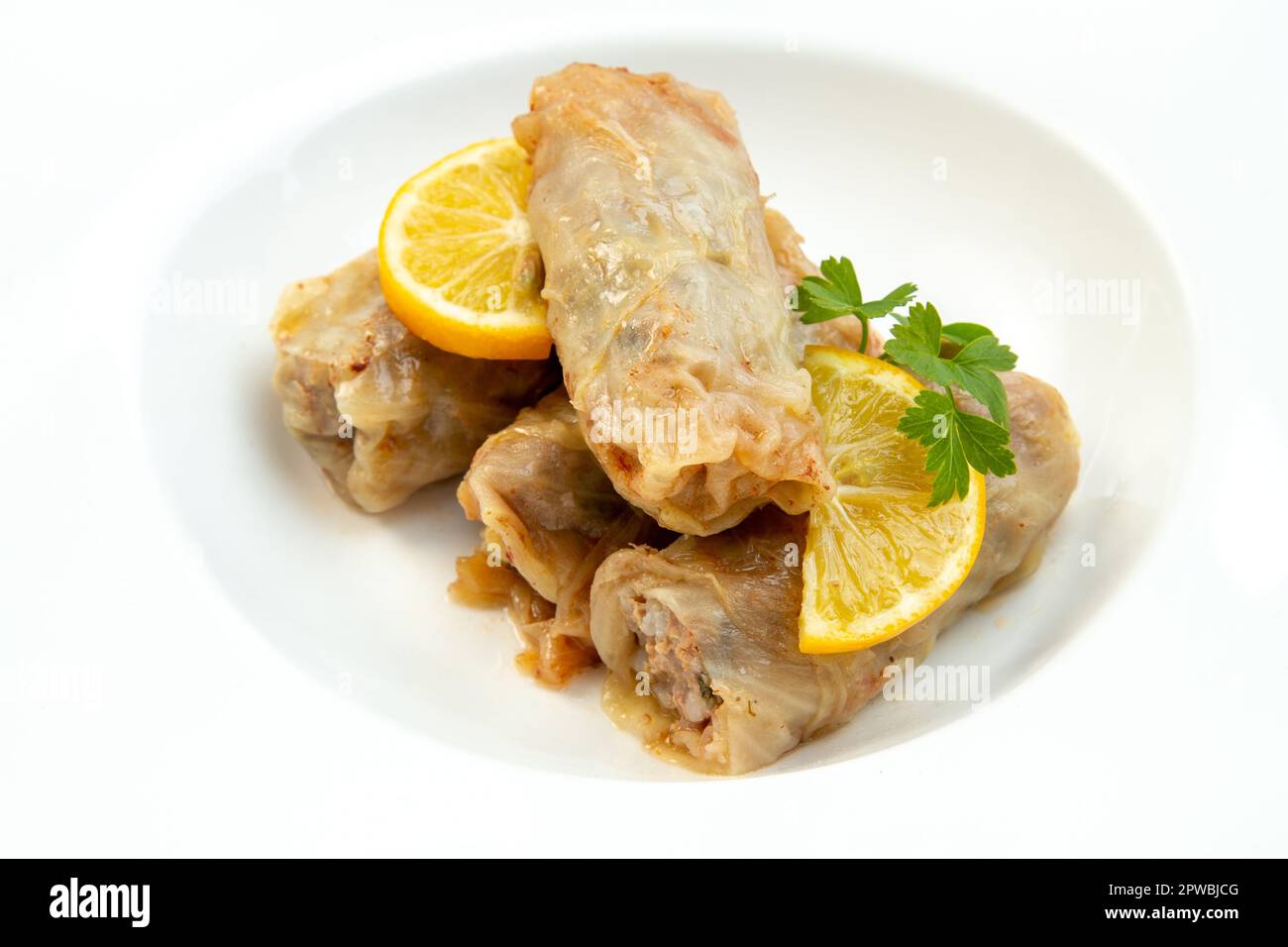 front close view cabbage dolma with lemon on a white background color ...