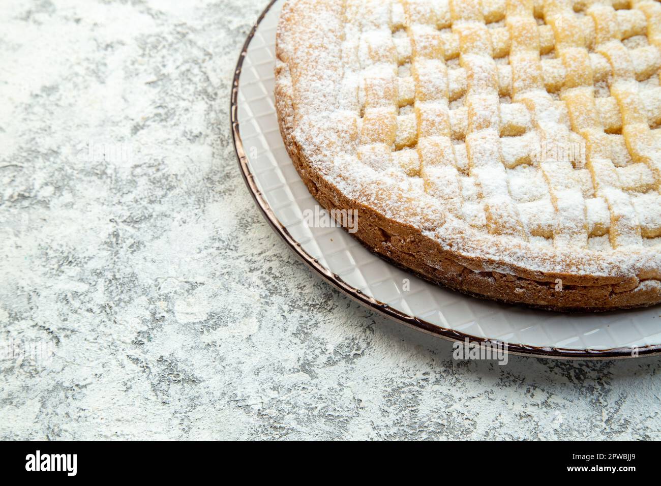 front view delicious sweet pie with sugar powder inside plate on white ...