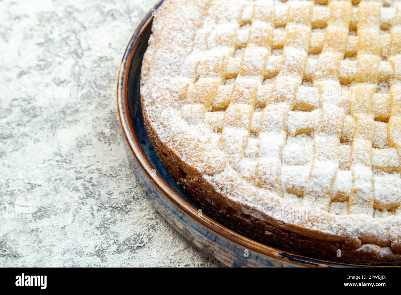 front view delicious sweet pie sugar powdered inside pan on white ...