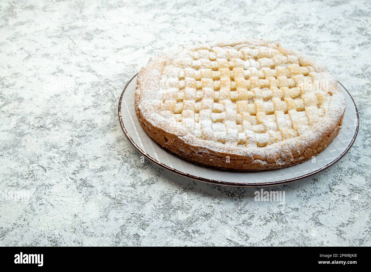 front view delicious sweet pie with sugar powder inside plate on white ...