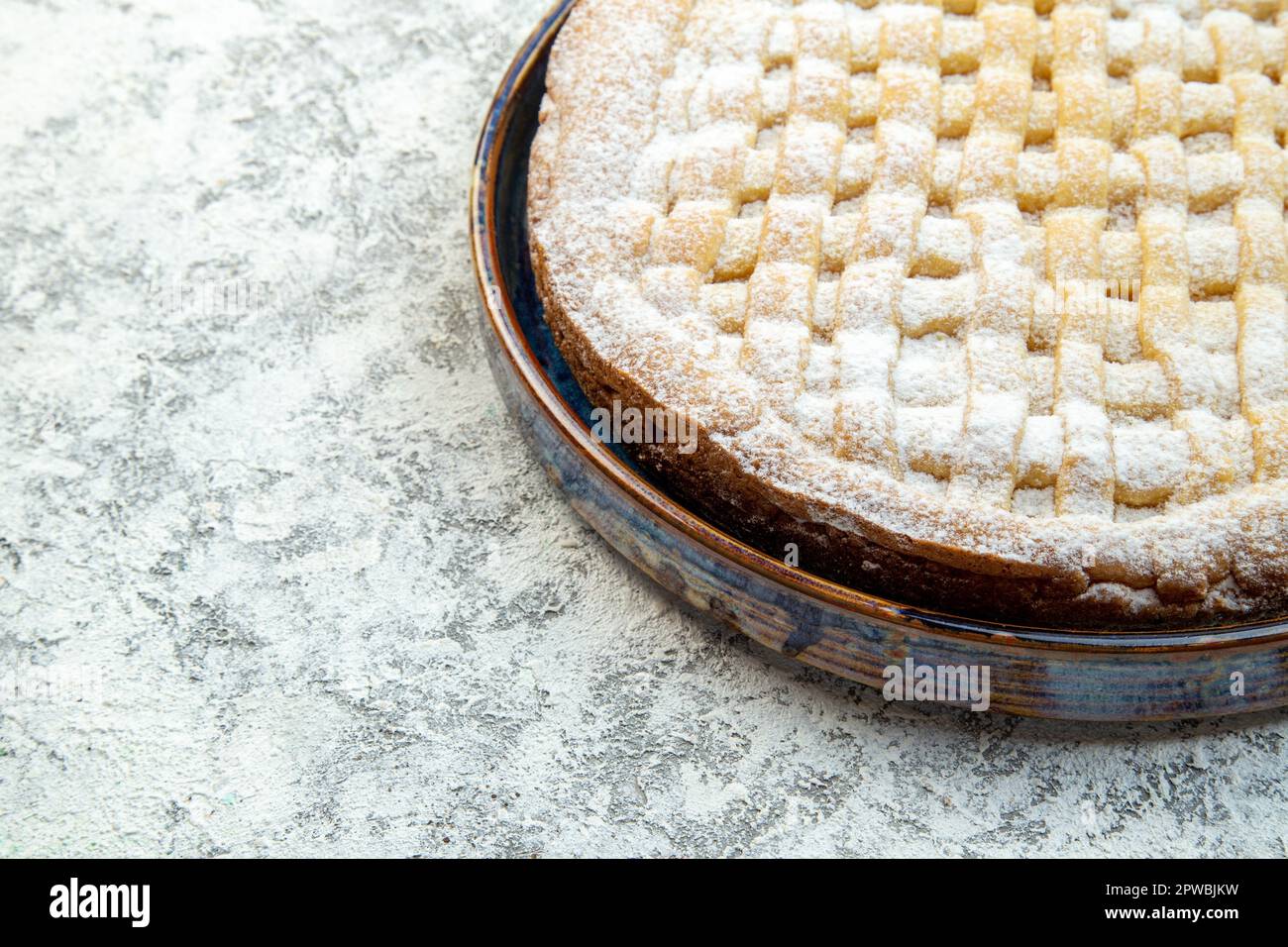 front view delicious sweet pie sugar powdered inside pan on white ...