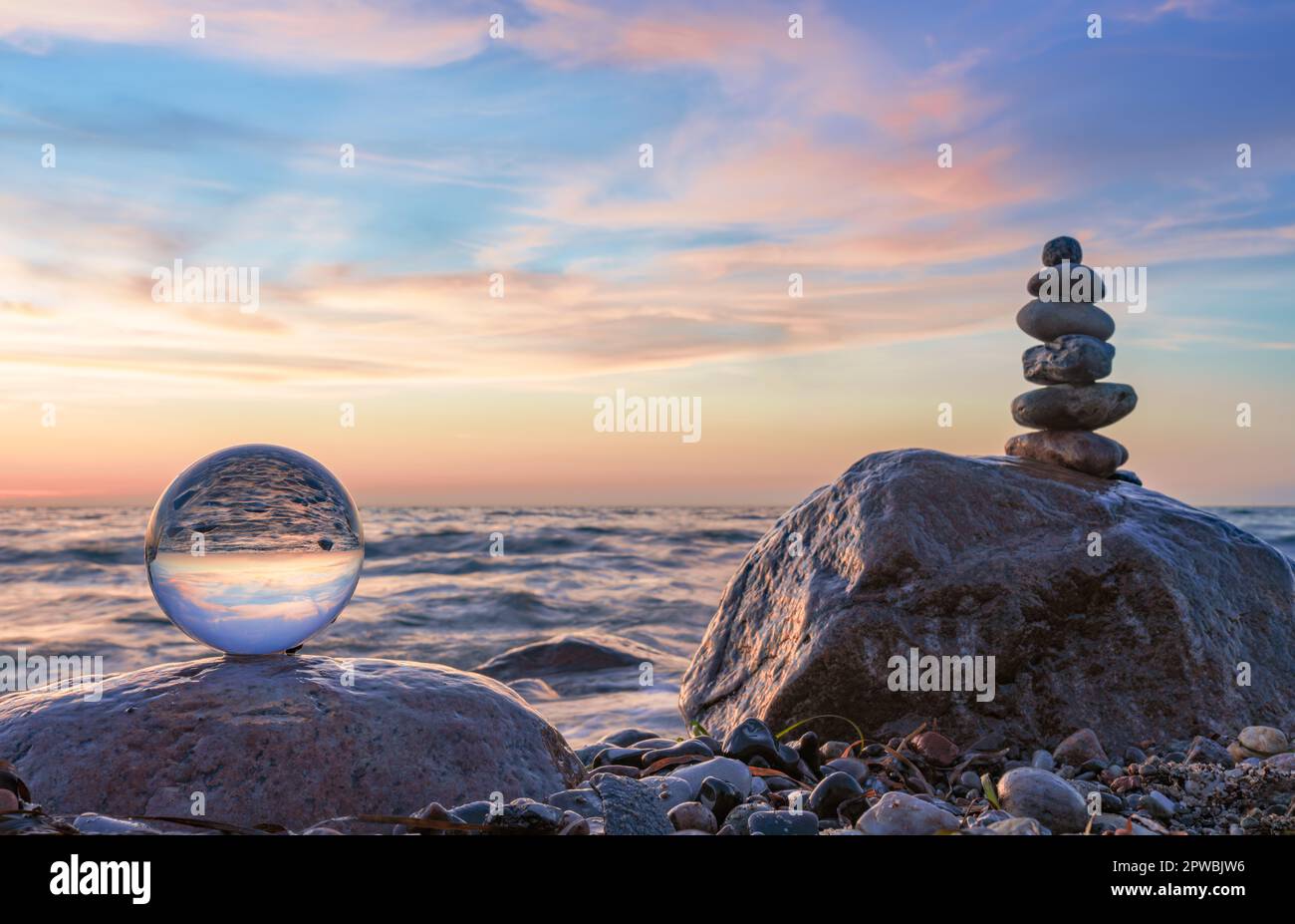 Stone pyramids and glass sphere on the dreamy Baltic Sea sand beach on ...
