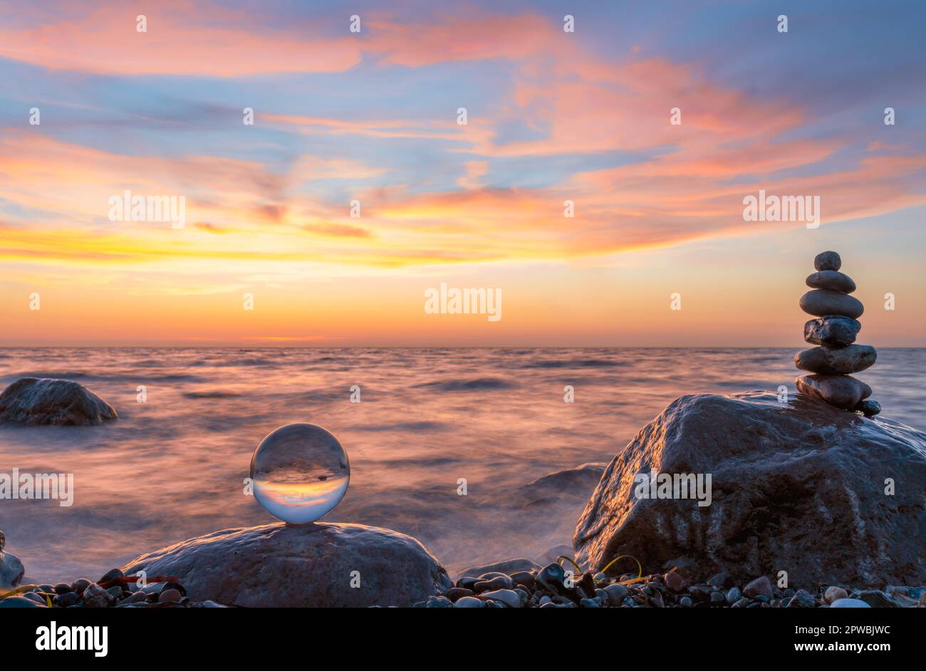 Stone pyramids and glass sphere on the dreamy Baltic Sea sand beach on ...