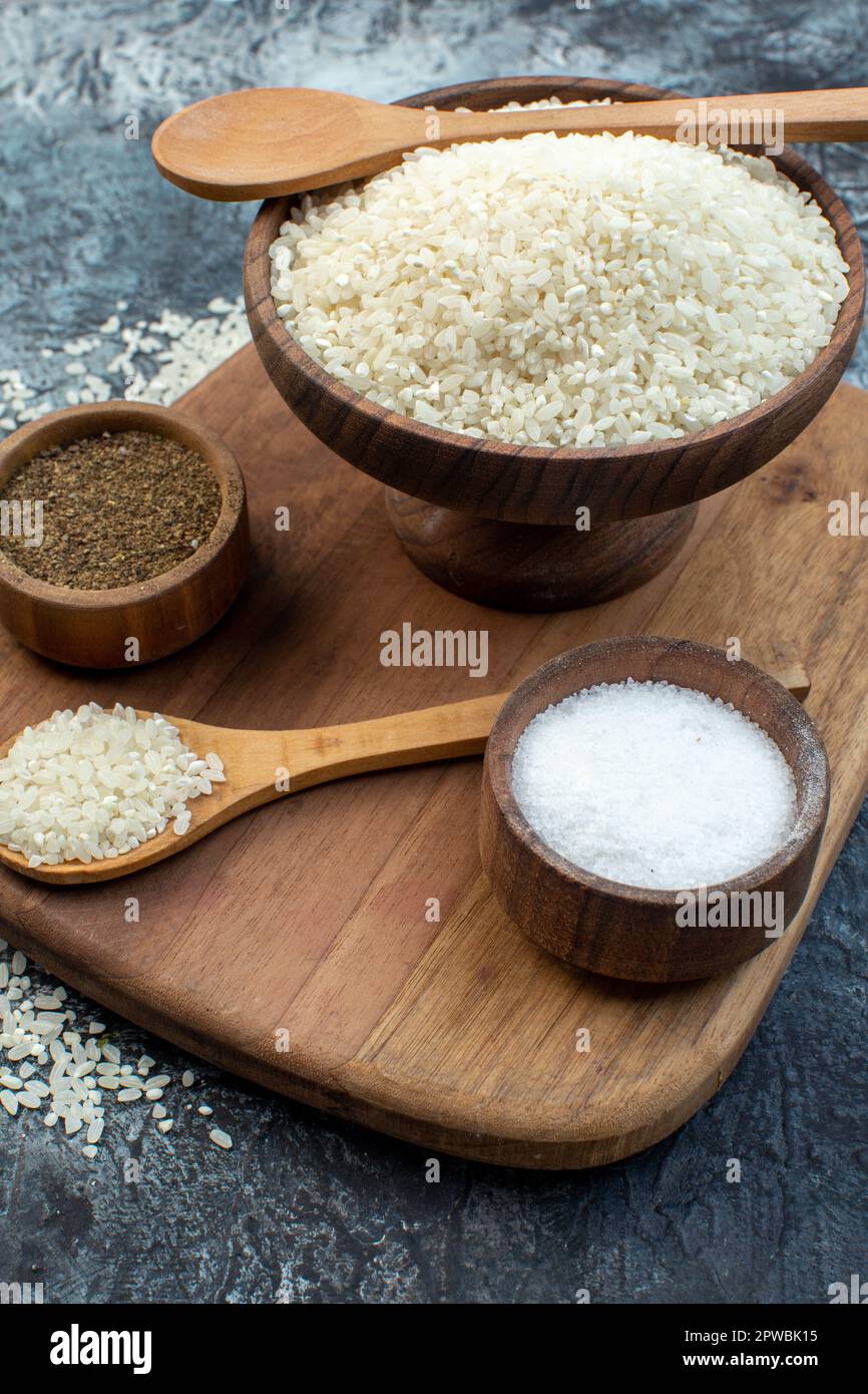 front view raw rice with seasonings on dark background seed cereal ...