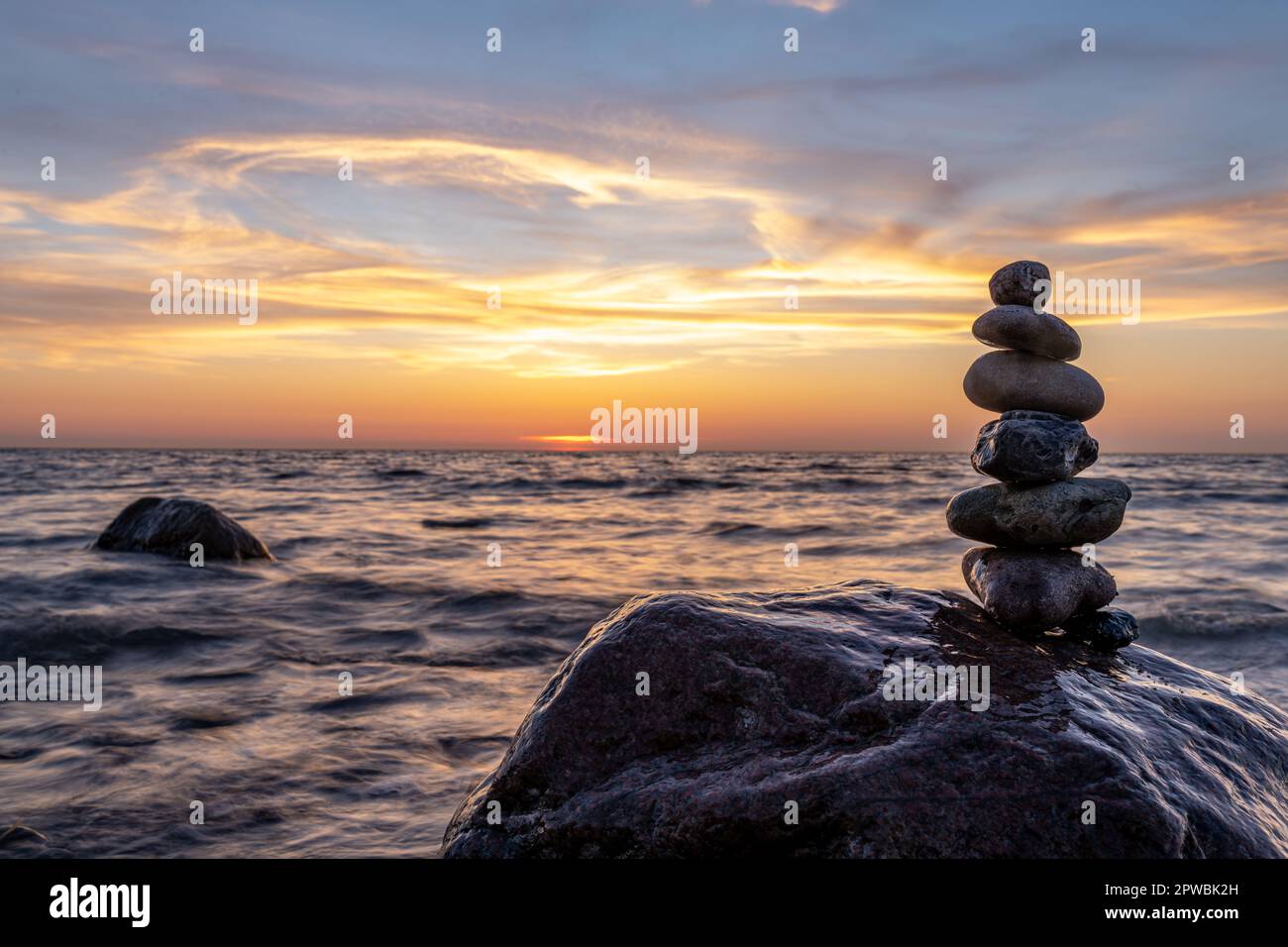 Stone pyramids and glass sphere on the dreamy Baltic Sea sand beach on ...