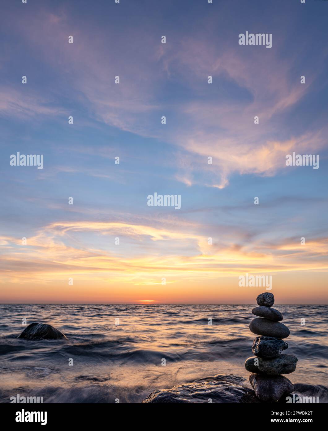 Stone pyramids and glass sphere on the dreamy Baltic Sea sand beach on ...