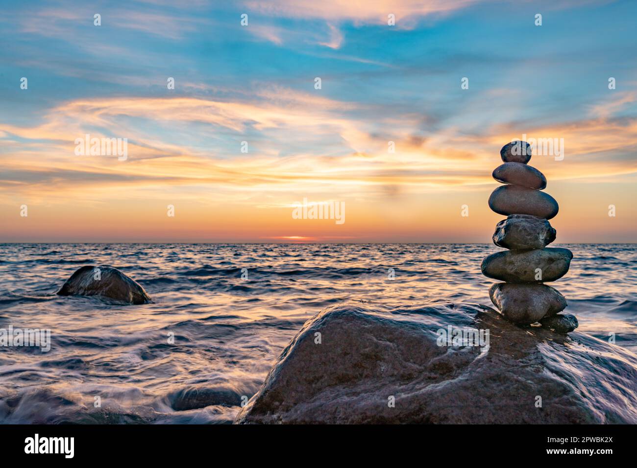 Stone pyramids and glass sphere on the dreamy Baltic Sea sand beach on ...