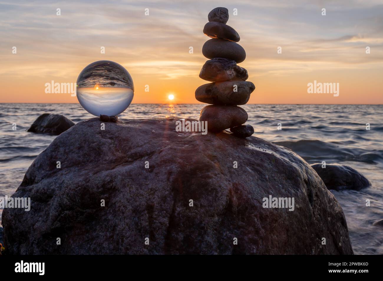 Stone pyramids and glass sphere on the dreamy Baltic Sea sand beach on ...