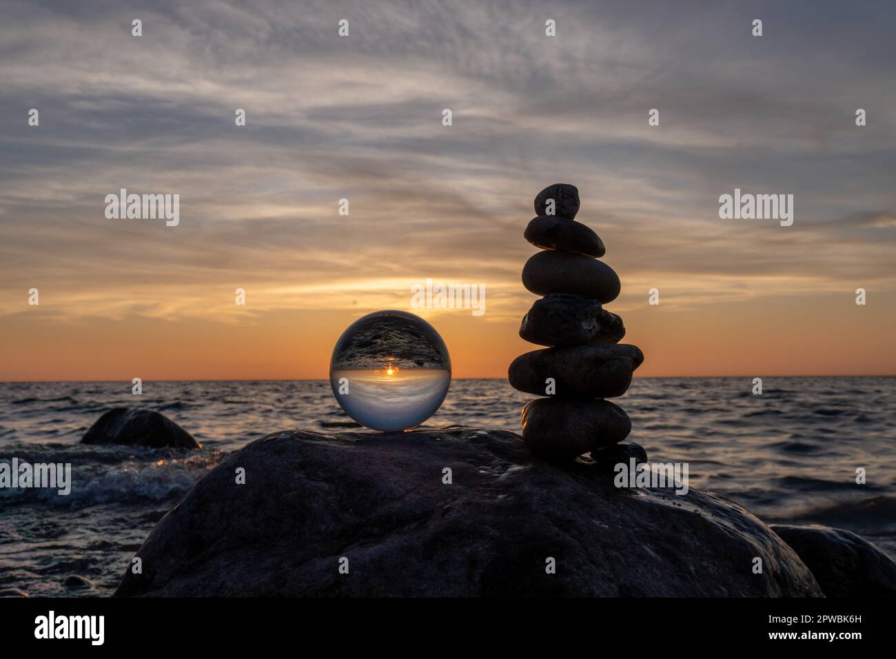 Stone pyramids and glass sphere on the dreamy Baltic Sea sand beach on ...