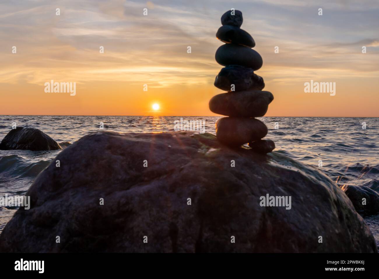 Stone pyramids and glass sphere on the dreamy Baltic Sea sand beach on ...