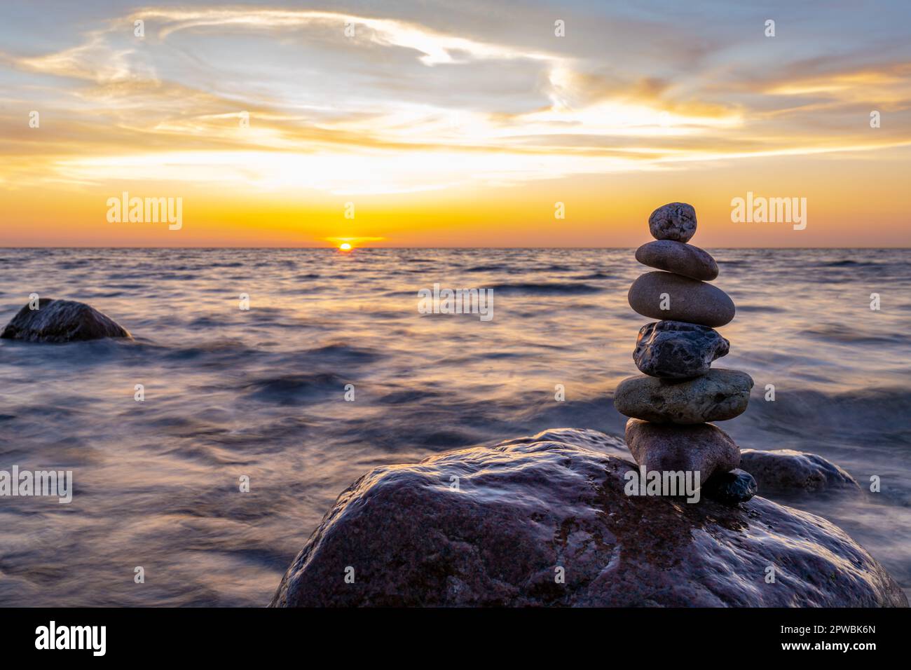 Stone pyramids and glass sphere on the dreamy Baltic Sea sand beach on ...
