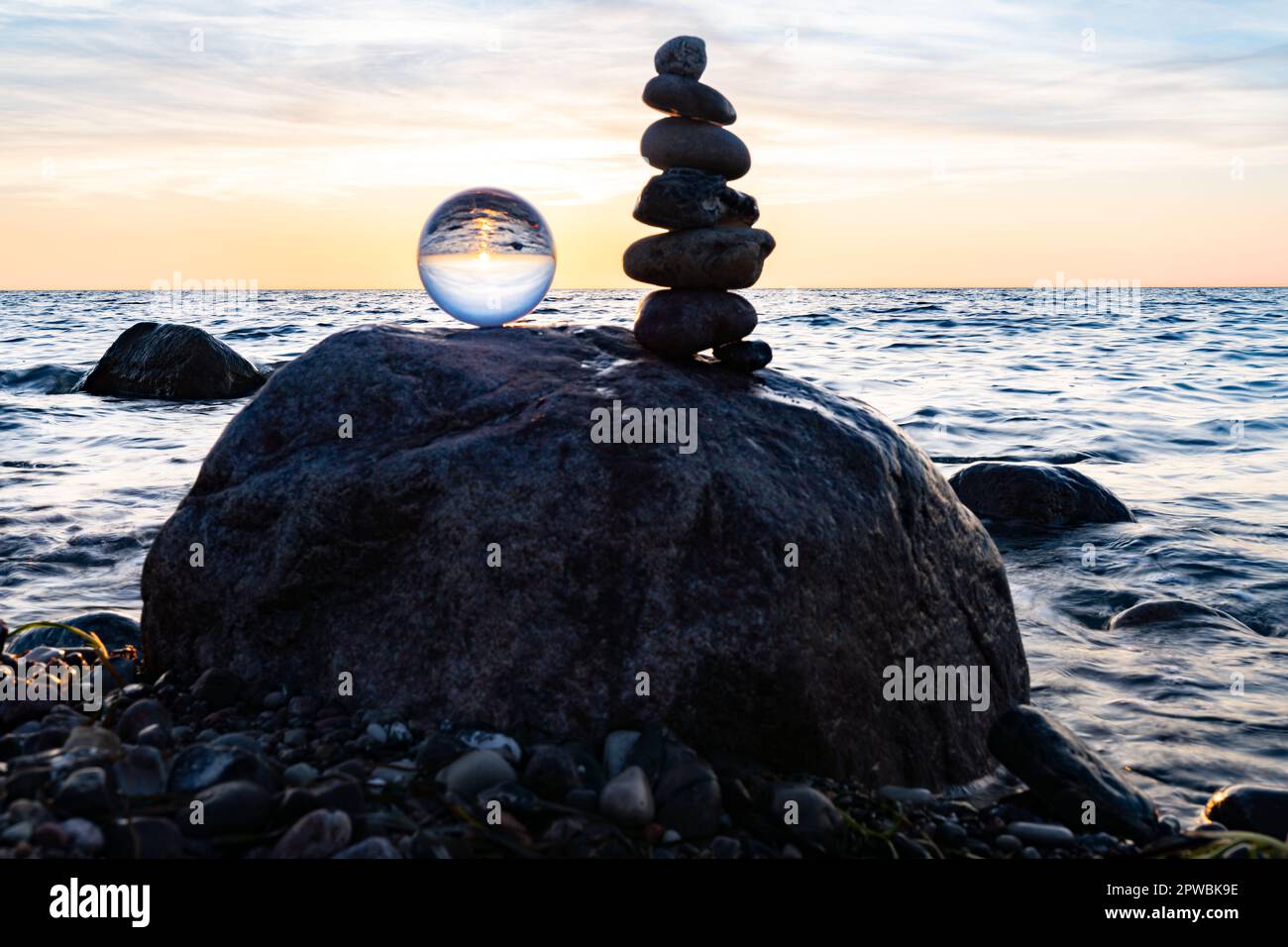 Stone pyramids and glass sphere on the dreamy Baltic Sea sand beach on ...
