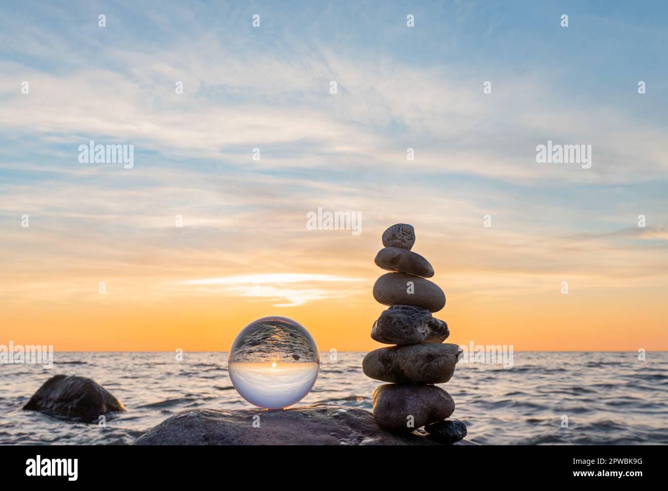 Stone pyramids and glass sphere on the dreamy Baltic Sea sand beach on ...