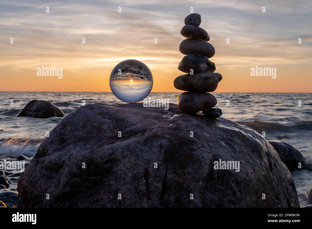 Stone pyramids and glass sphere on the dreamy Baltic Sea sand beach on ...