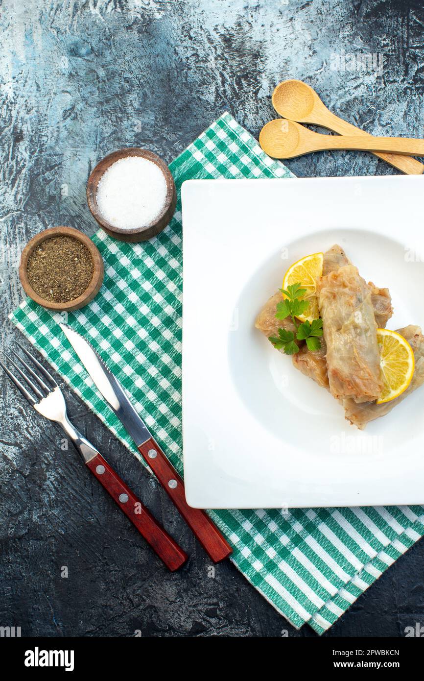top view cabbage dolma with lemon and seasonings on dark background ...