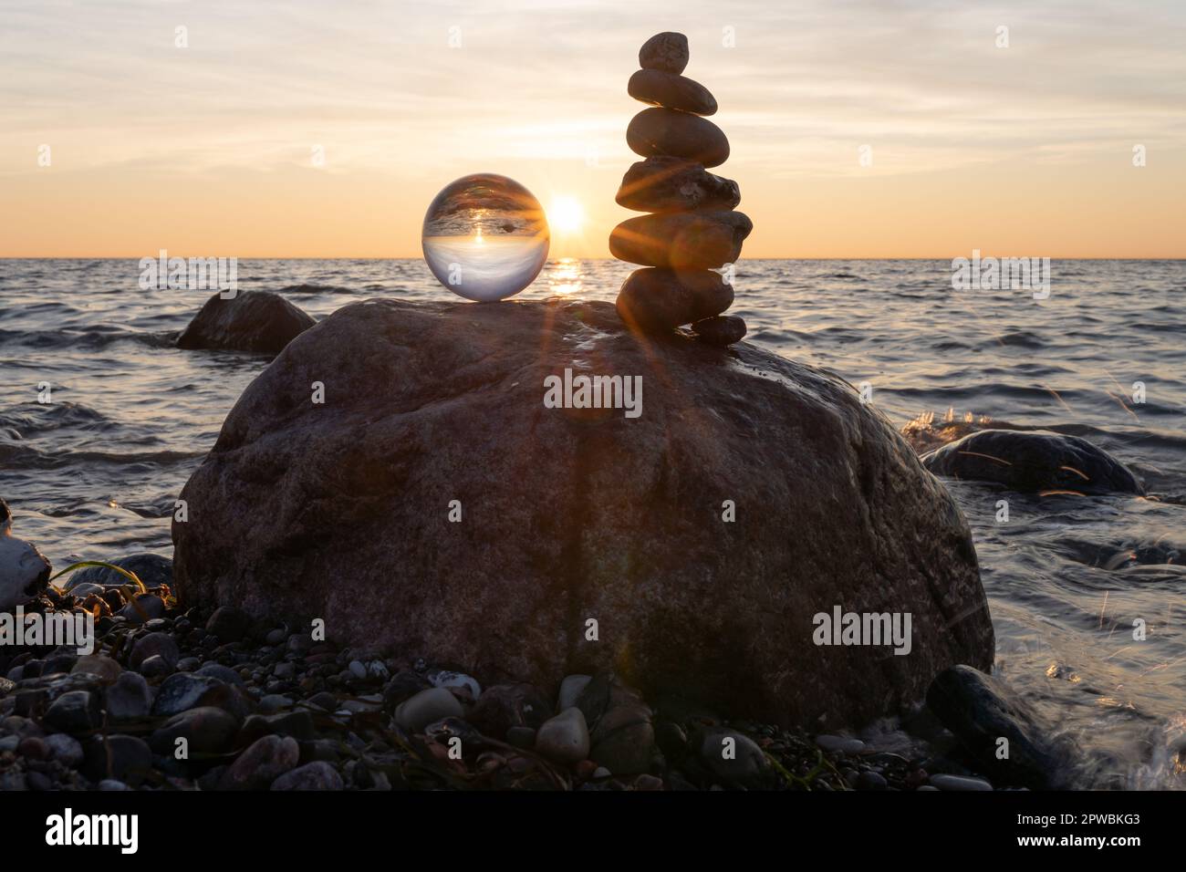 Stone pyramids and glass sphere on the dreamy Baltic Sea sand beach on ...