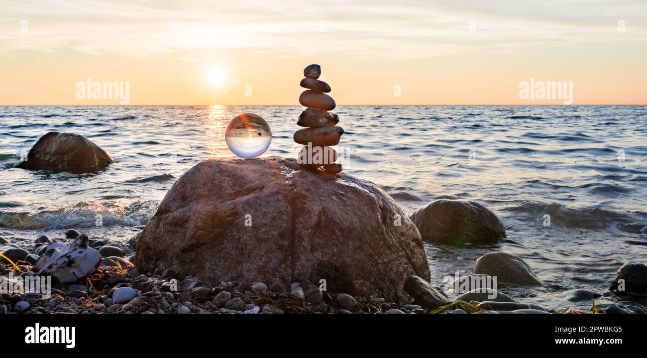 Stone pyramids and glass sphere on the dreamy Baltic Sea sand beach on ...